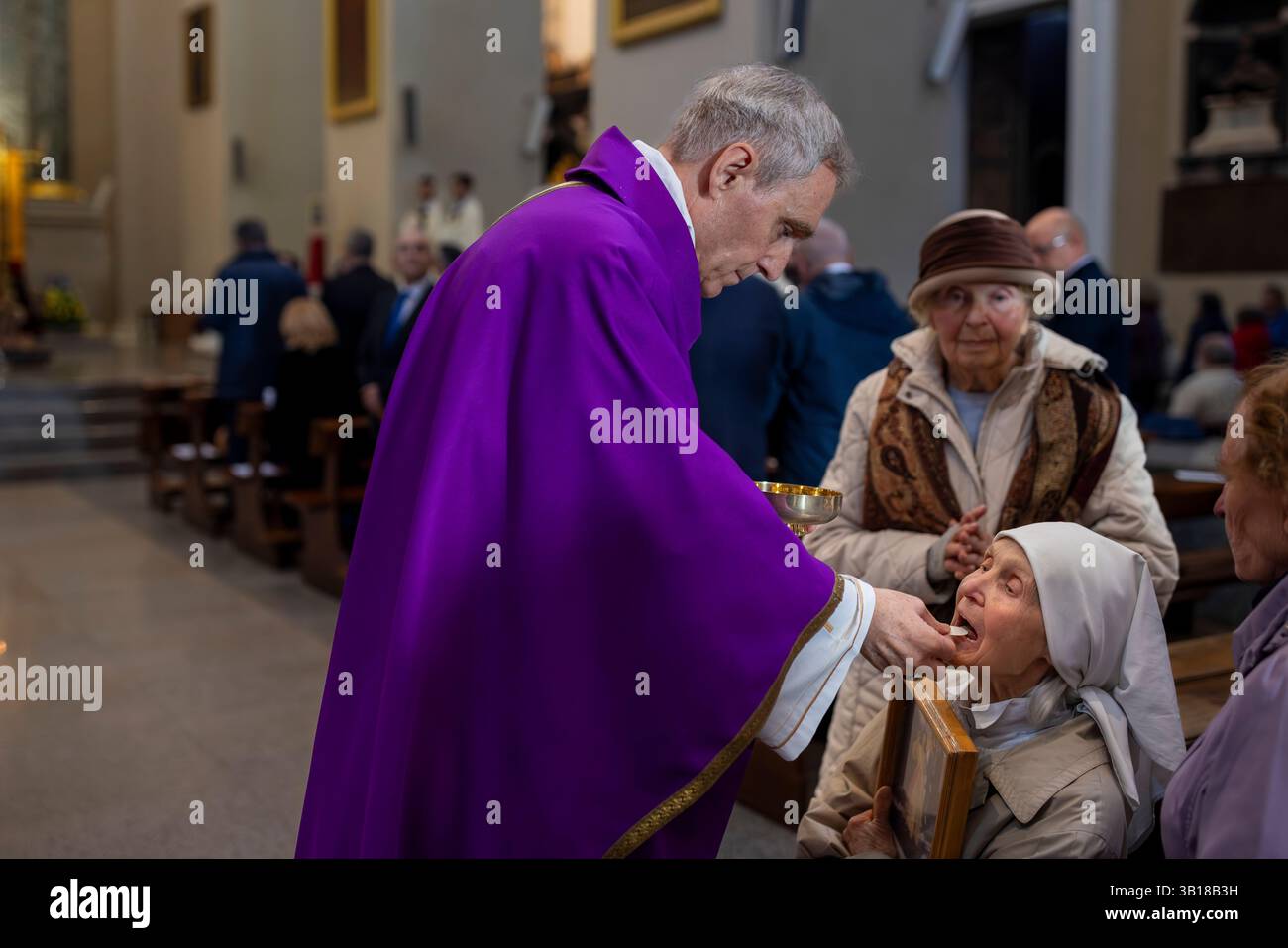 Apostolic Nuncio, Archbishop Dr. Georg Gänswein distributes communion ...