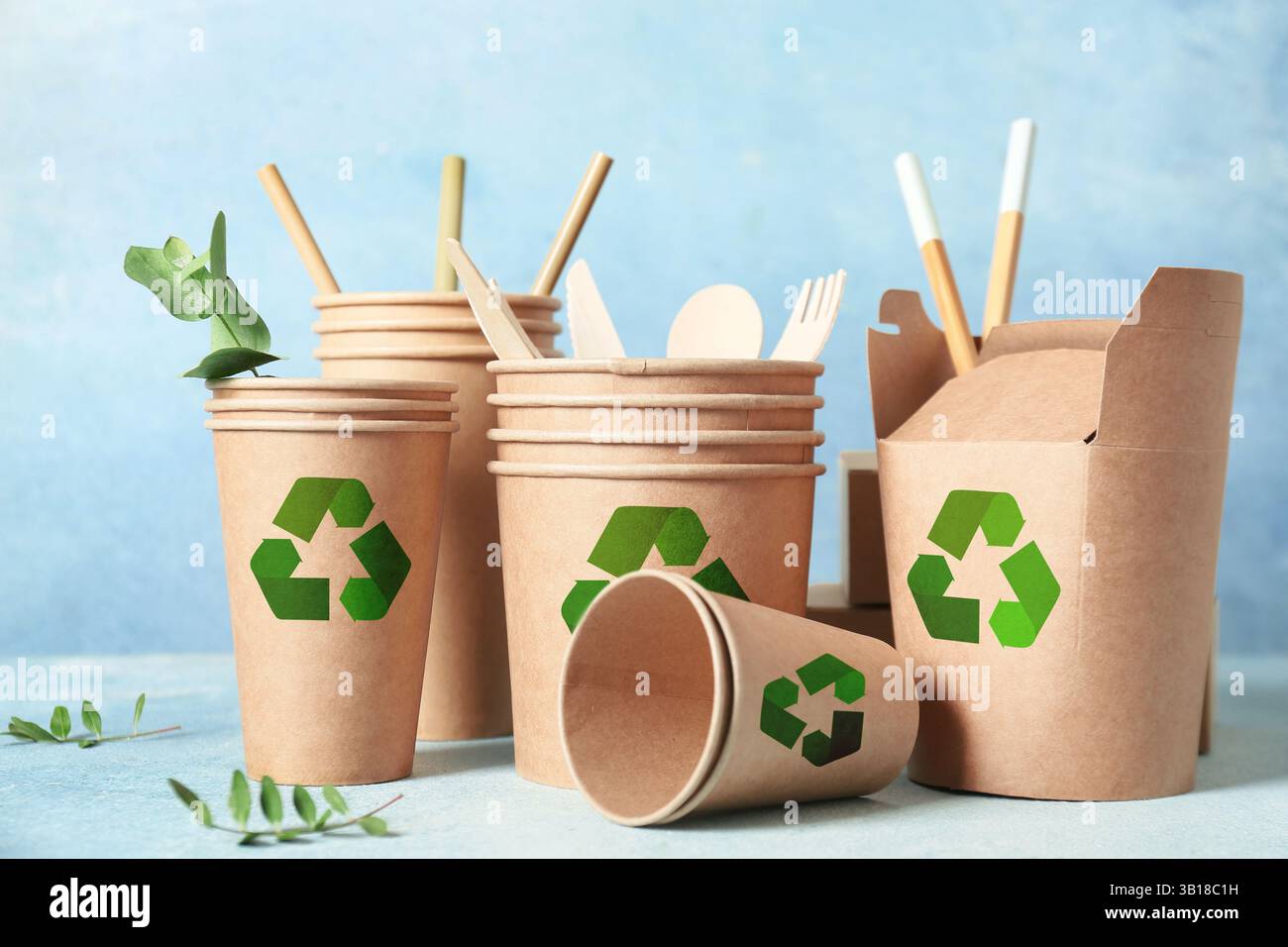 Eco containers for food and drinks with recycling signs on light blue ...