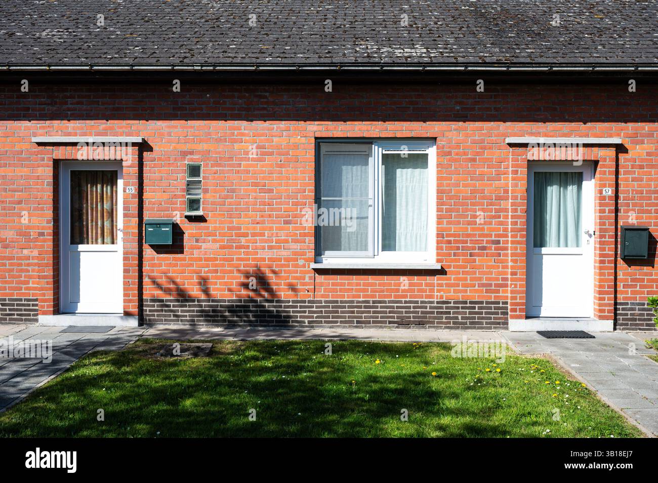 Residential brick stone houses in a row with small frontyard in Ieper ...