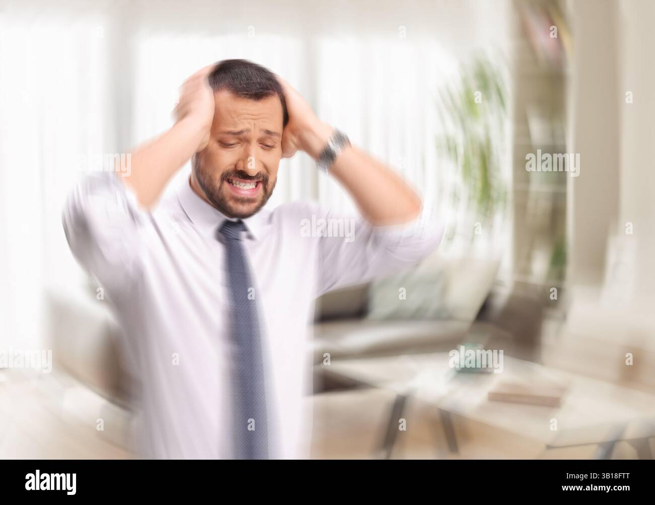 Stressed man with headache feeling dizzy at home Stock Photo - Alamy