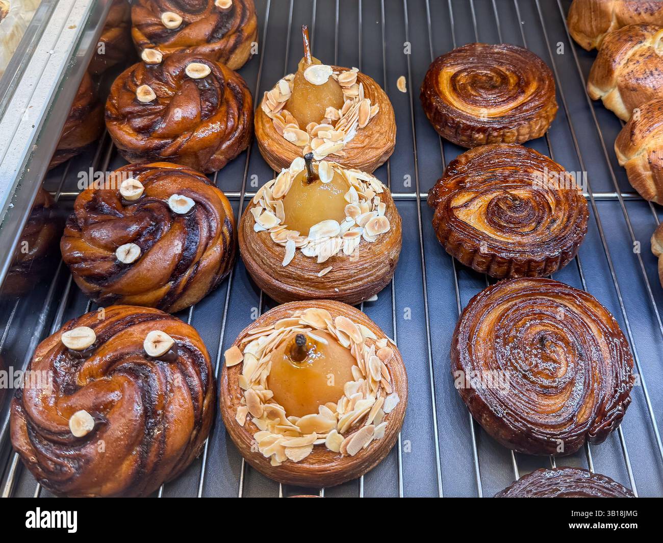 Assorted gourmet desserts in bakery display. Variety and modern pastry ...