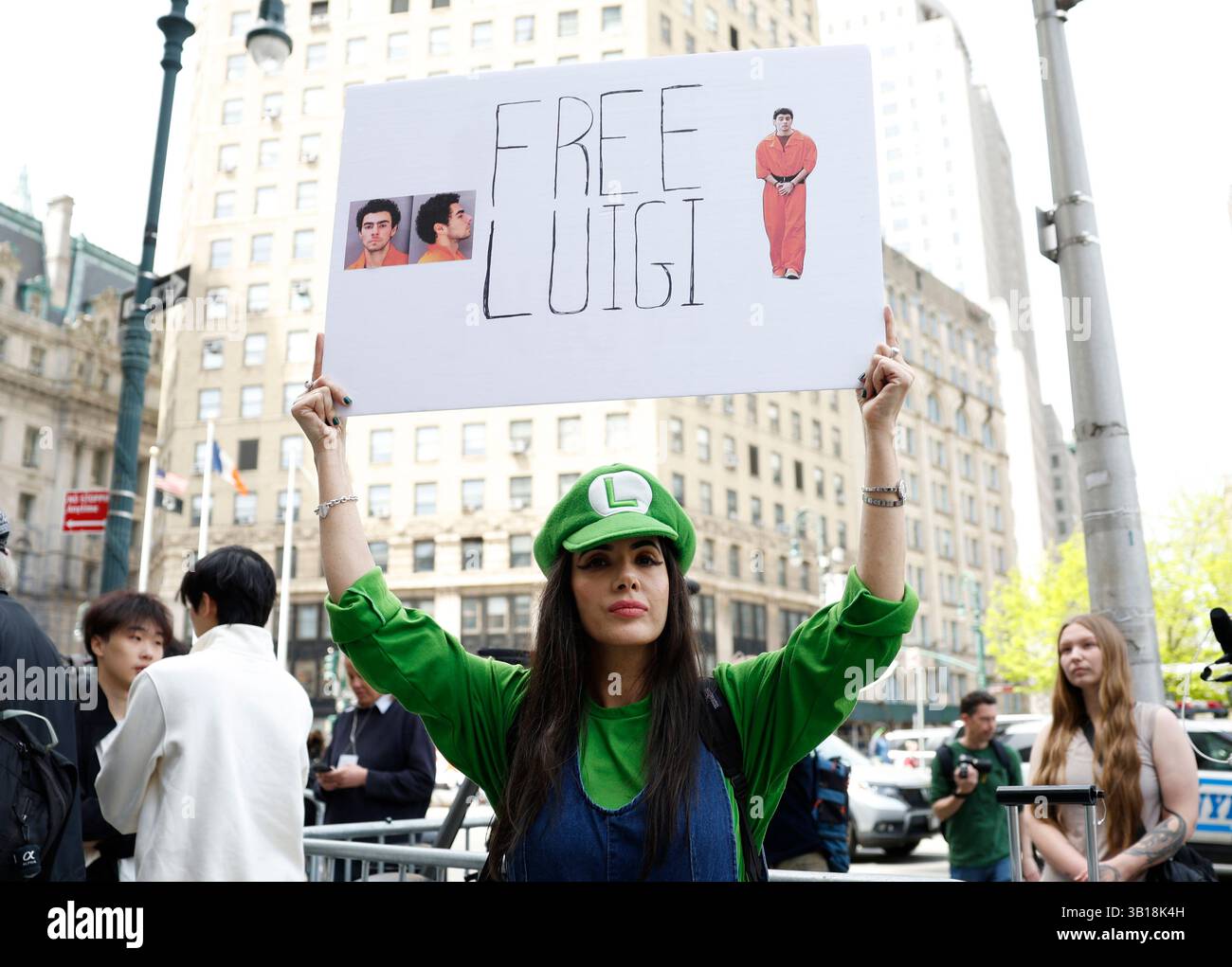 New York, United States. 25th Apr, 2025. Supporters hold signs outside ...
