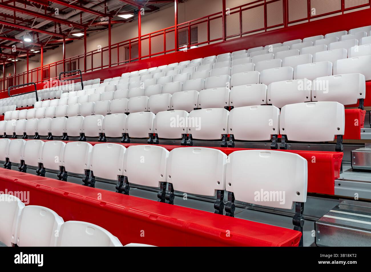 Close-up image of red and white plastic folding bleacher seats in an ...