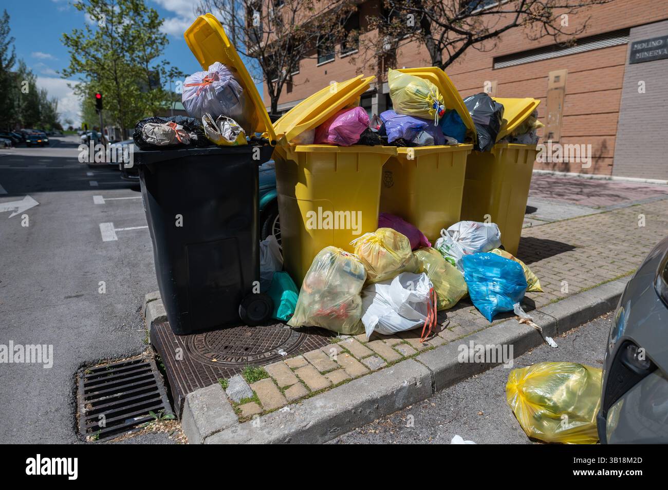 Madrid, Spain. 25th Apr, 2025. Garbage bins are seen full of waste ...