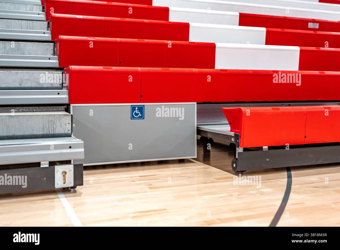 Accessible symbol on the front row of red and white plastic interior ...