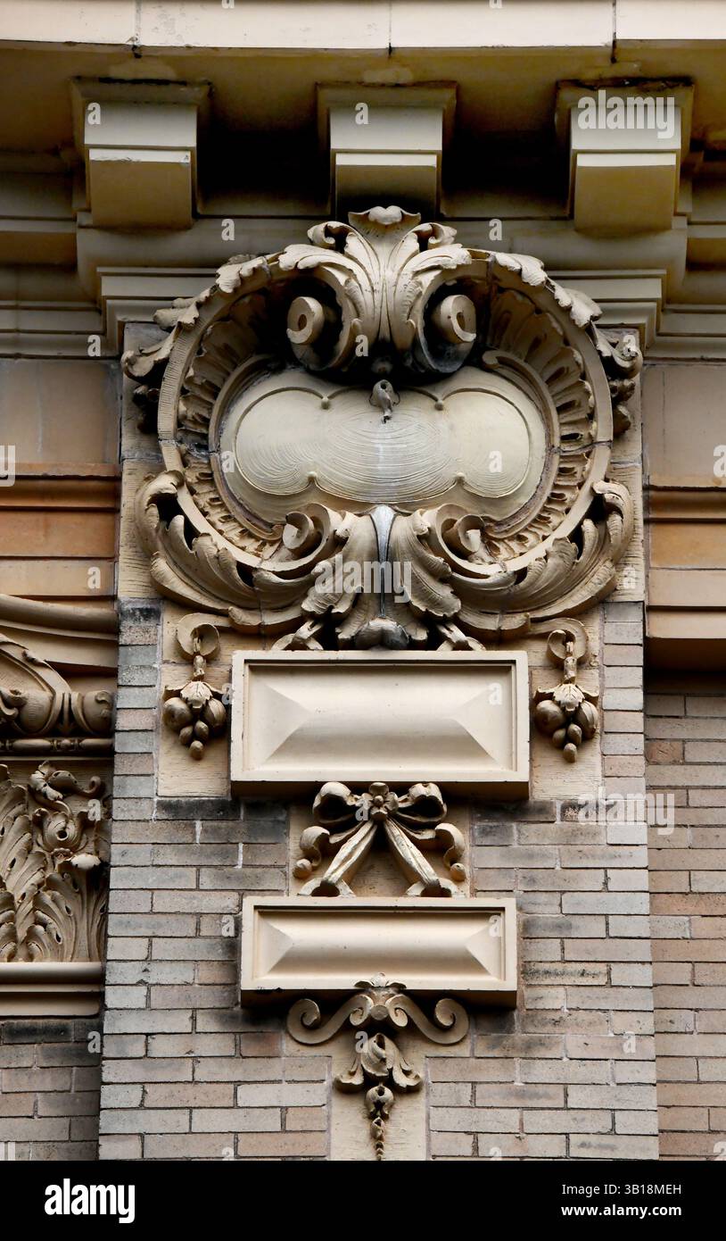 Brick column is decorated with intricate stonework. Column is on the ...