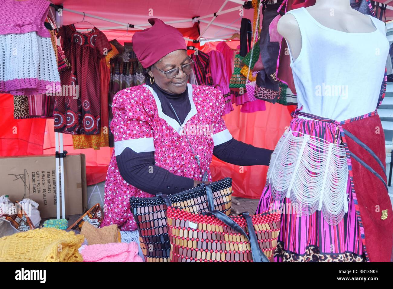Windhoek, Namibia. 25th Apr, 2025. A woman showcases artisanal products ...