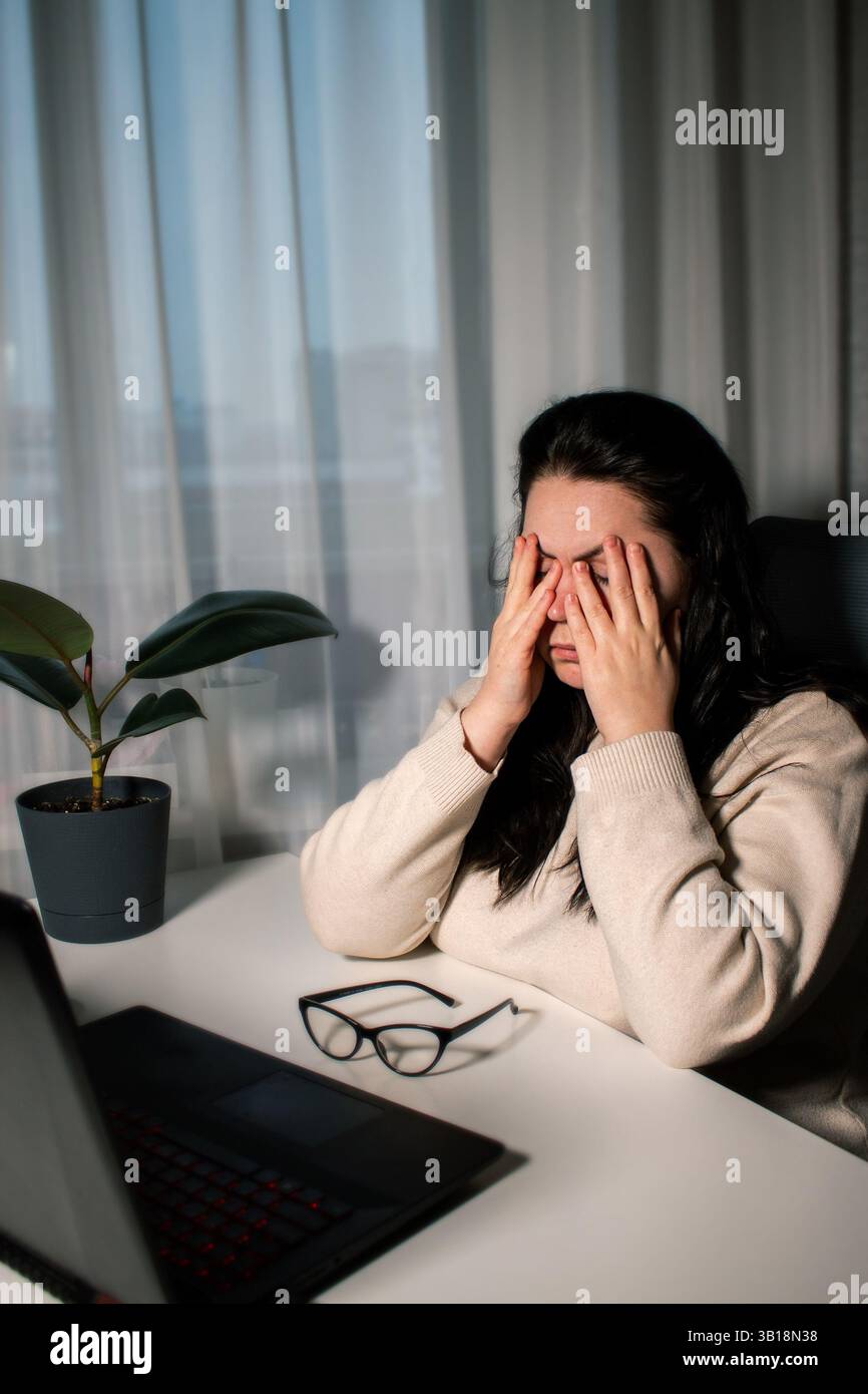 Young freelancer working from home feeling tired after working whole ...
