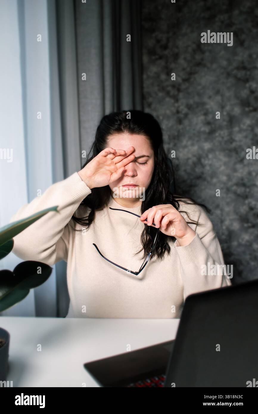 Tired business woman having fatigue and headache during work with ...