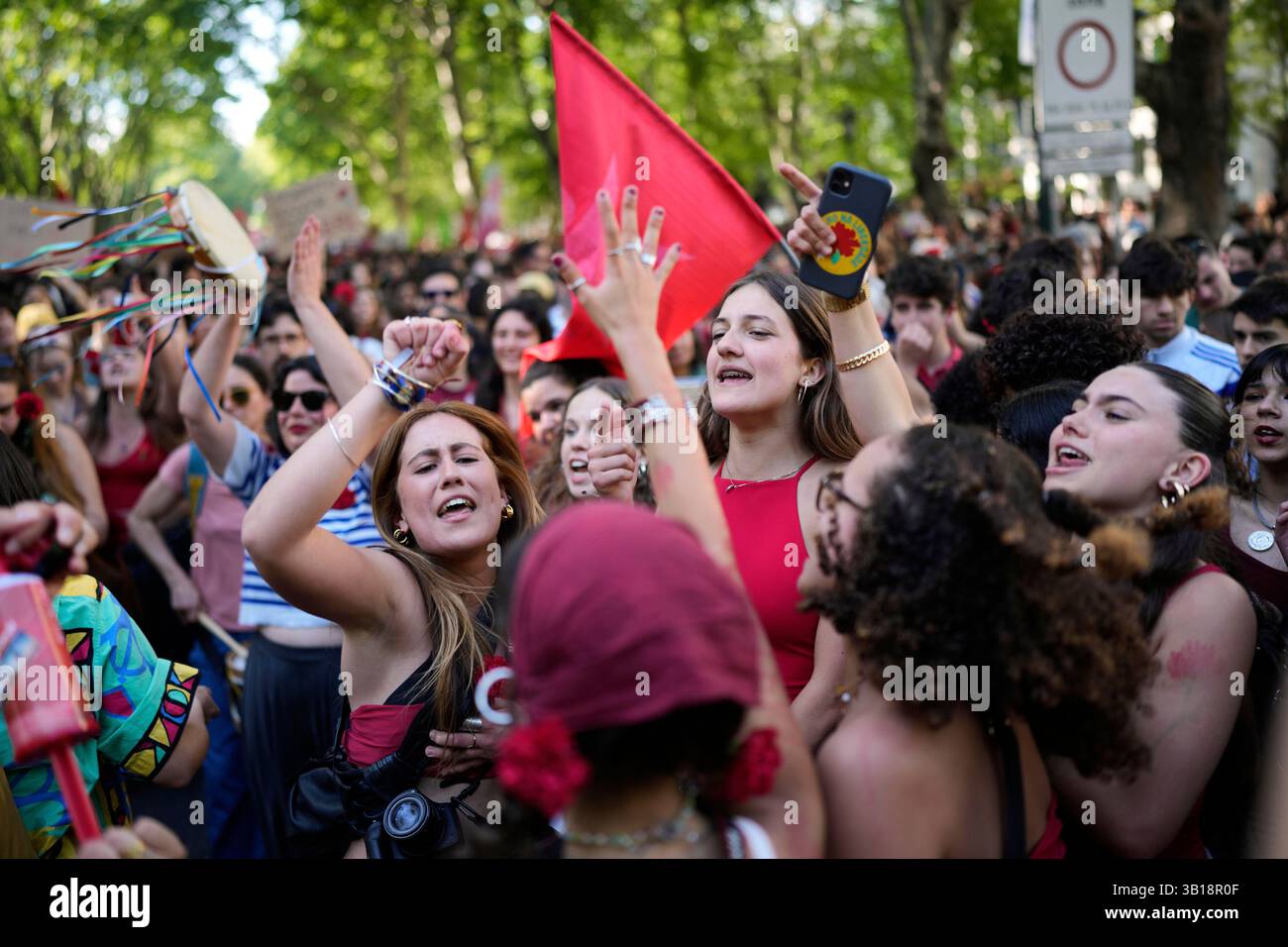 A group of women shout slogans while marching with tens of thousands ...