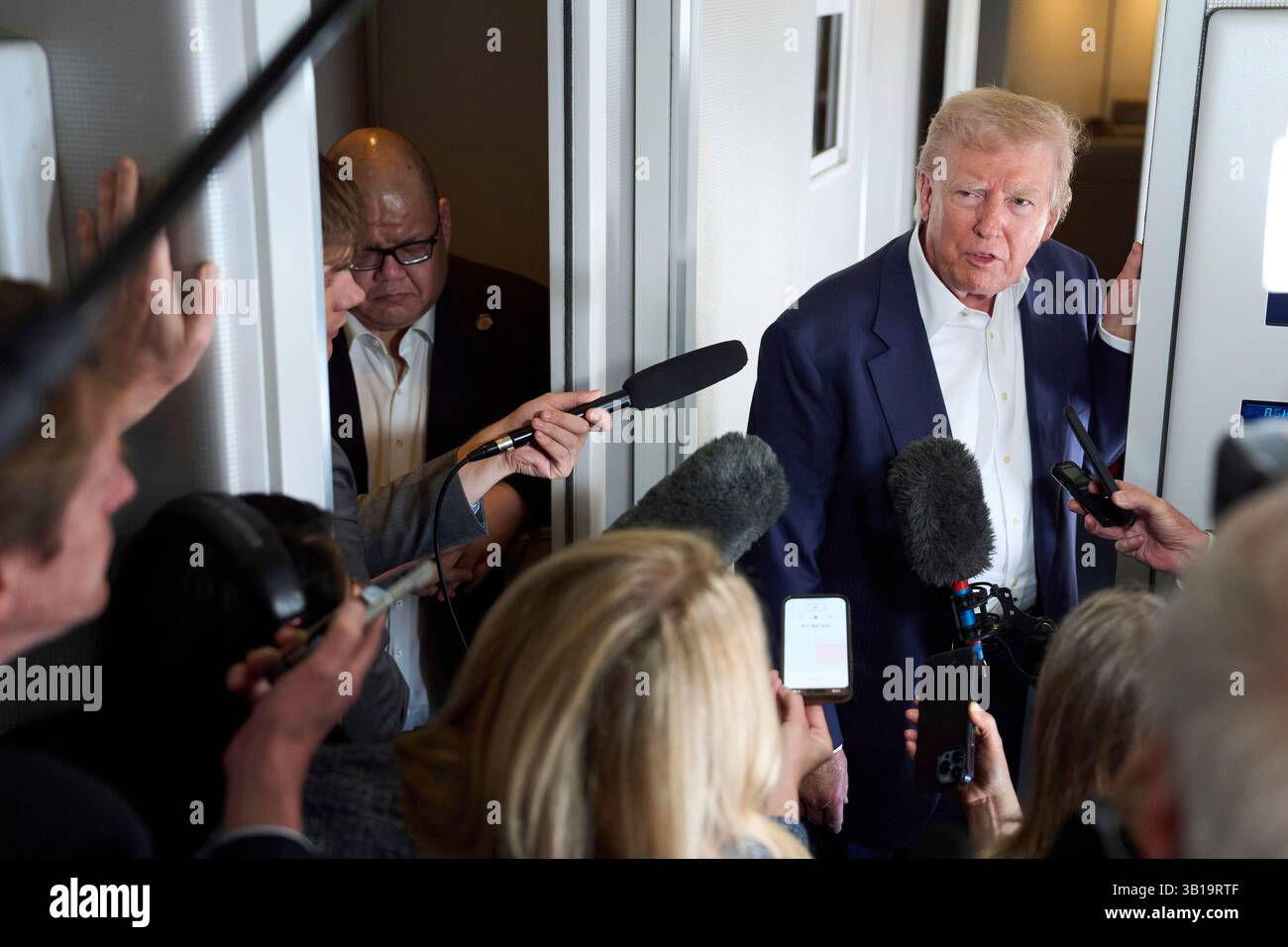 President Donald Trump speaks with reporters on Air Force One as he ...