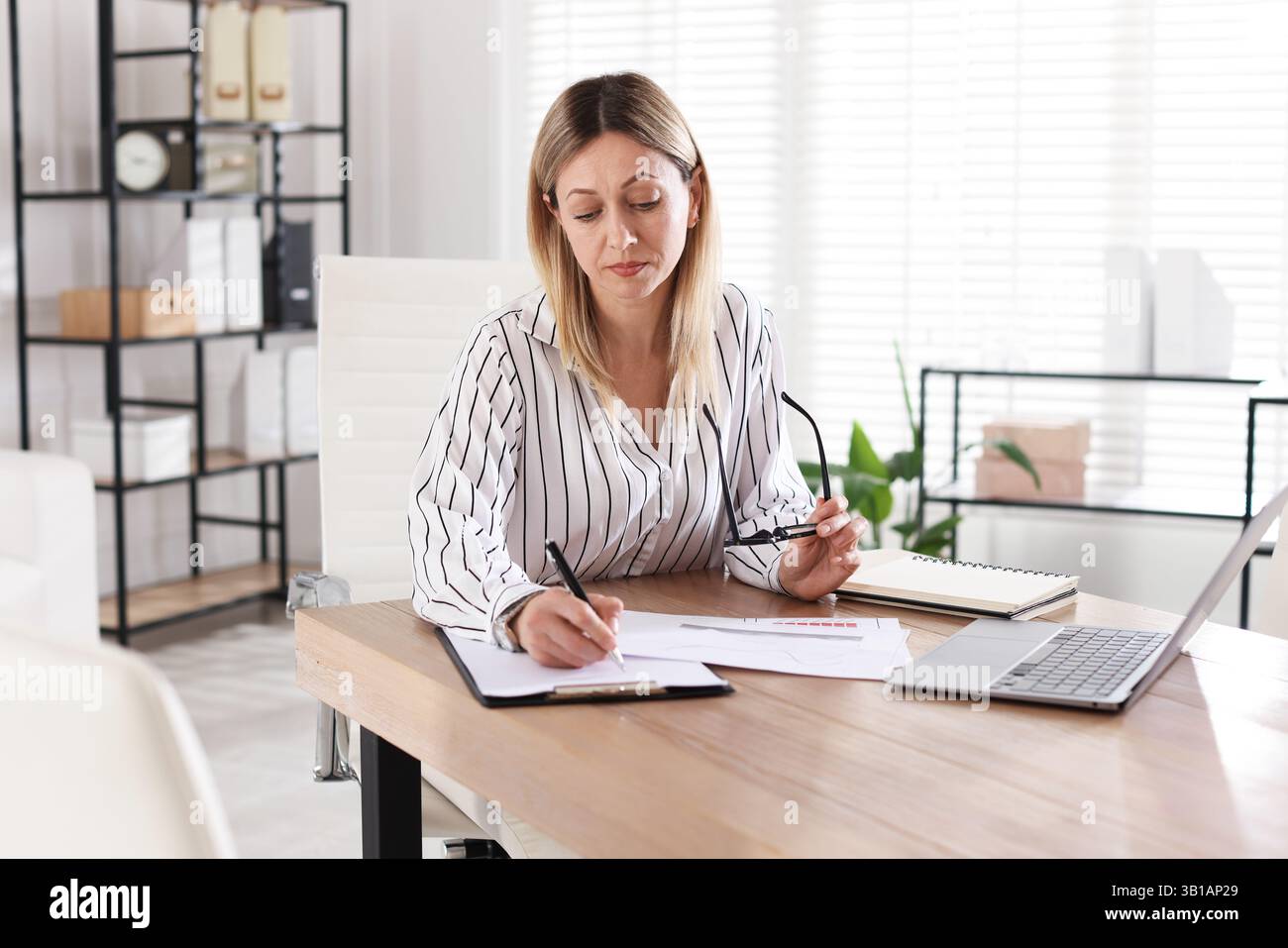 Professional banker working at desk in office Stock Photo - Alamy