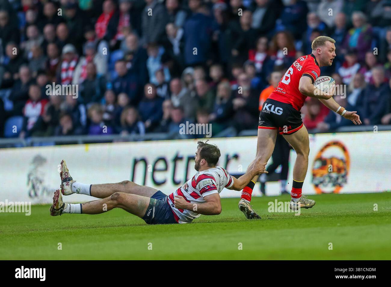 James Meadows fends off an Oldham defender *** during the Betfred ...