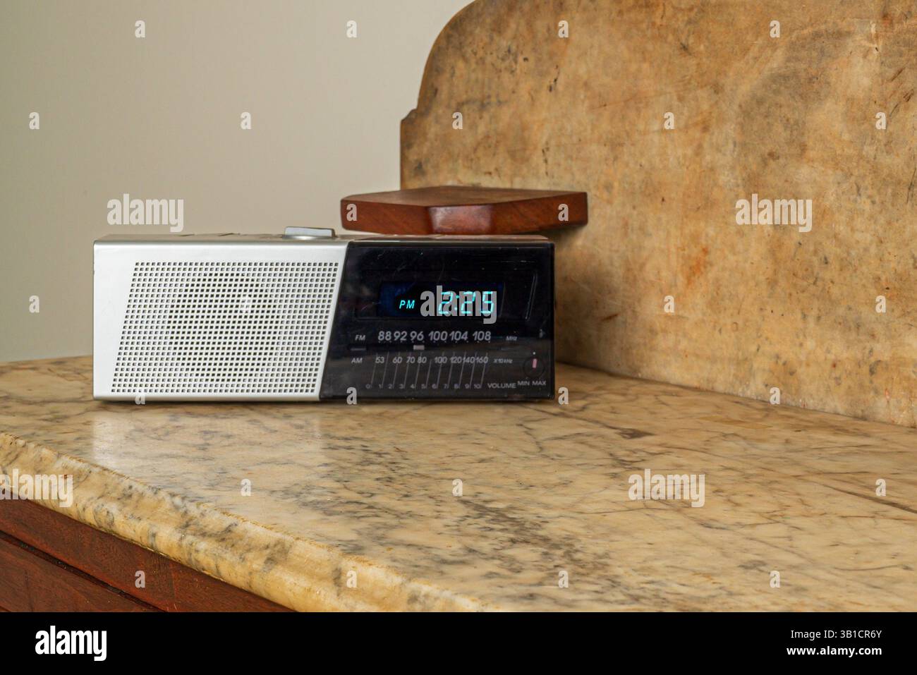 Vintage digital alarm clock sitting on marble counter Stock Photo - Alamy
