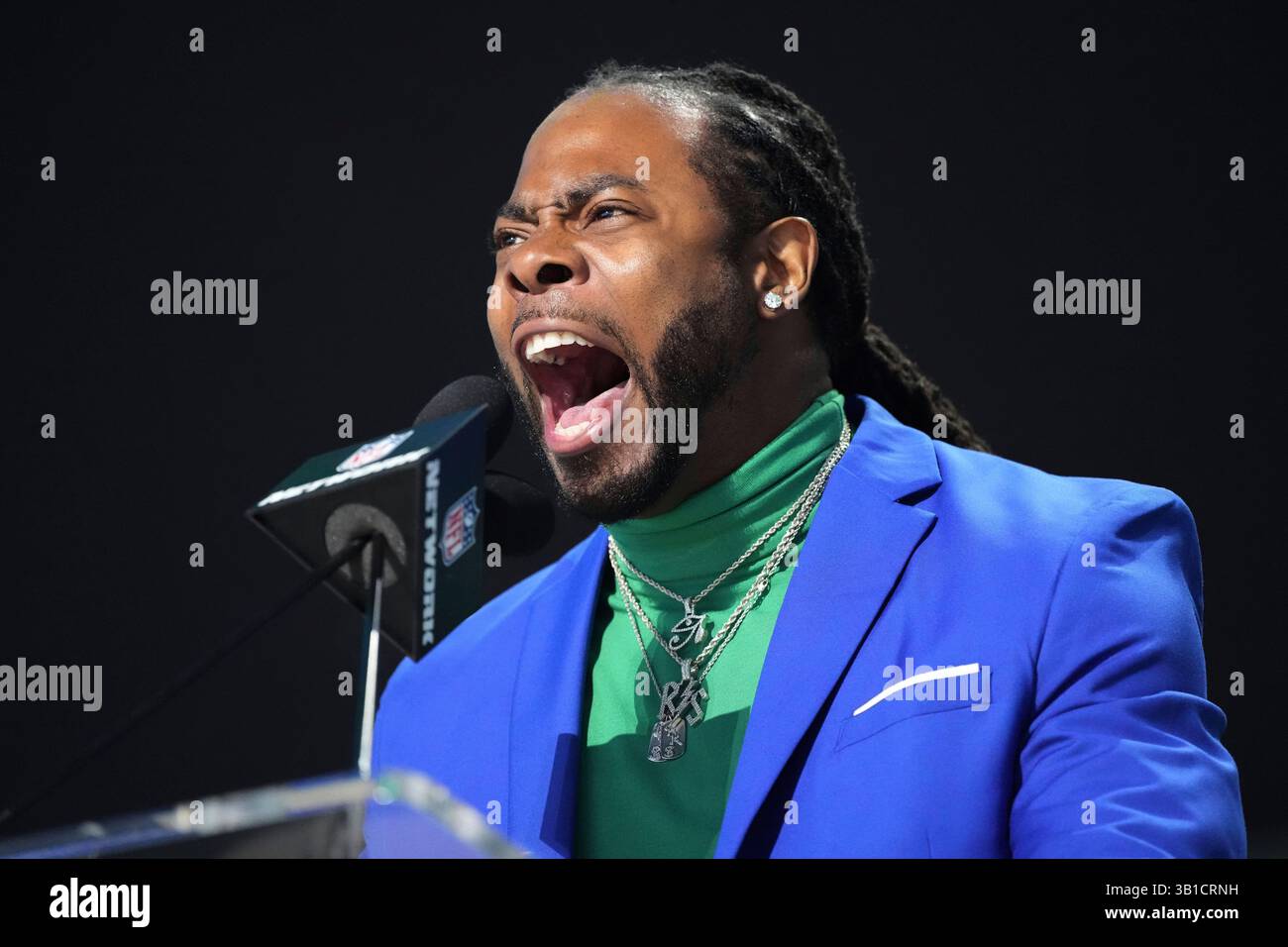 Former NFL player Richard Sherman announces a pick by the Seattle ...