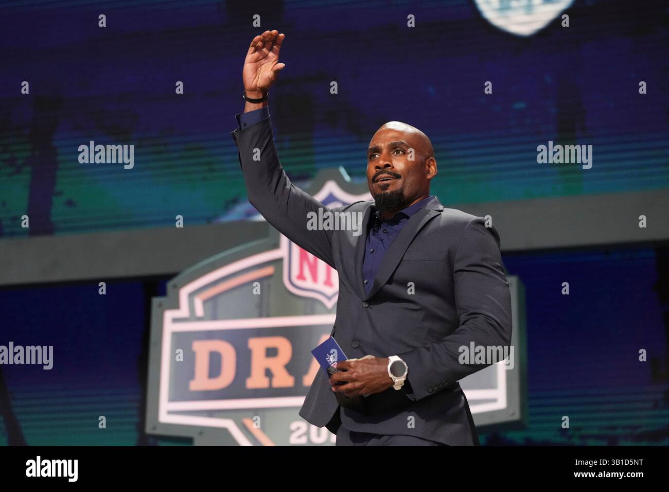 Former NFL player Dez White motions while announcing a draft pick for ...