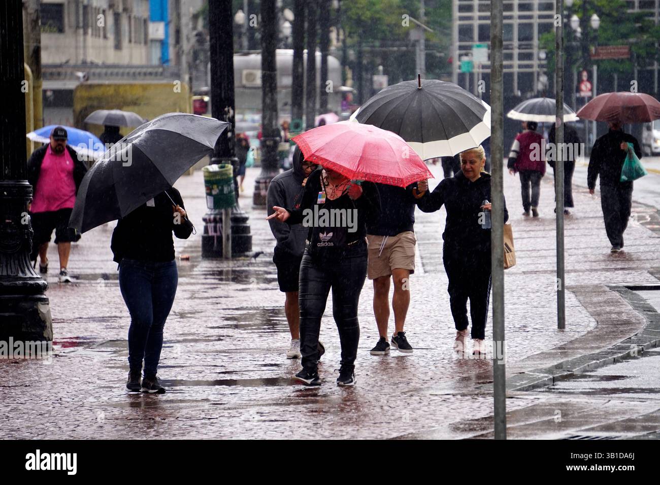 Pedestrians walk on a rainy day in downtown São Paulo on Friday ...