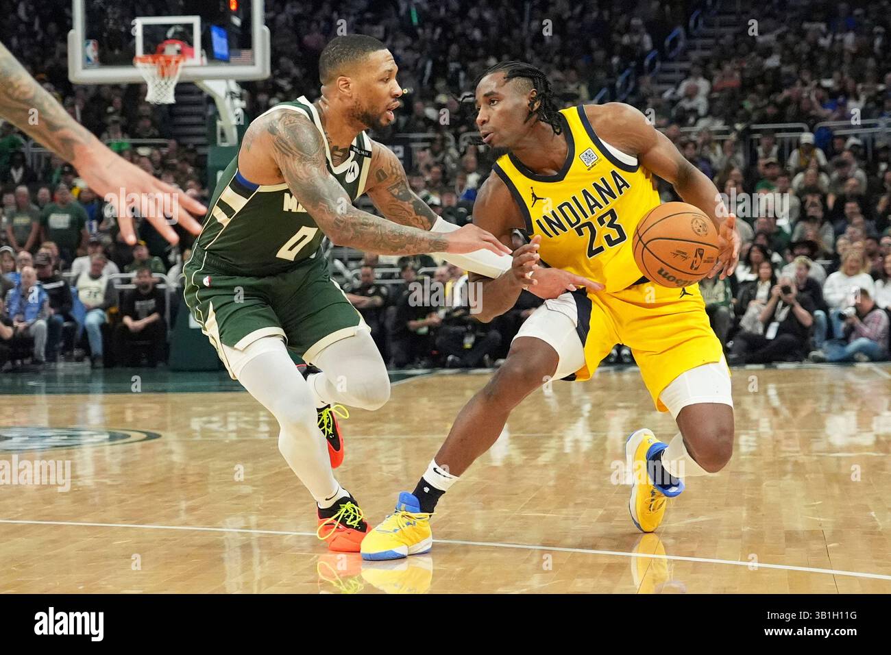 Milwaukee Bucks guard Damian Lillard, left, guards against Indiana ...