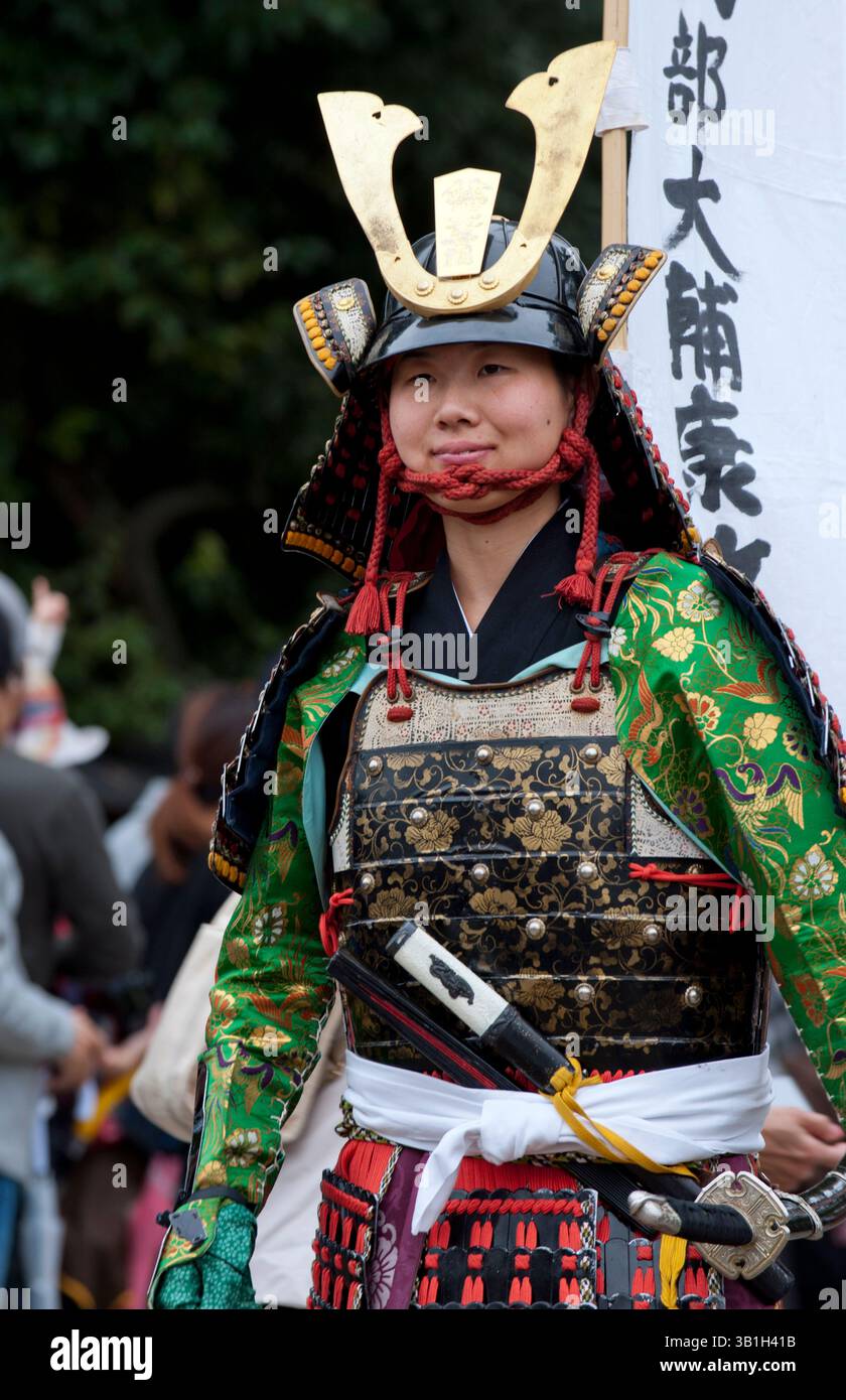 Woman in samurai armor costume with kabuto helmet participates in the ...