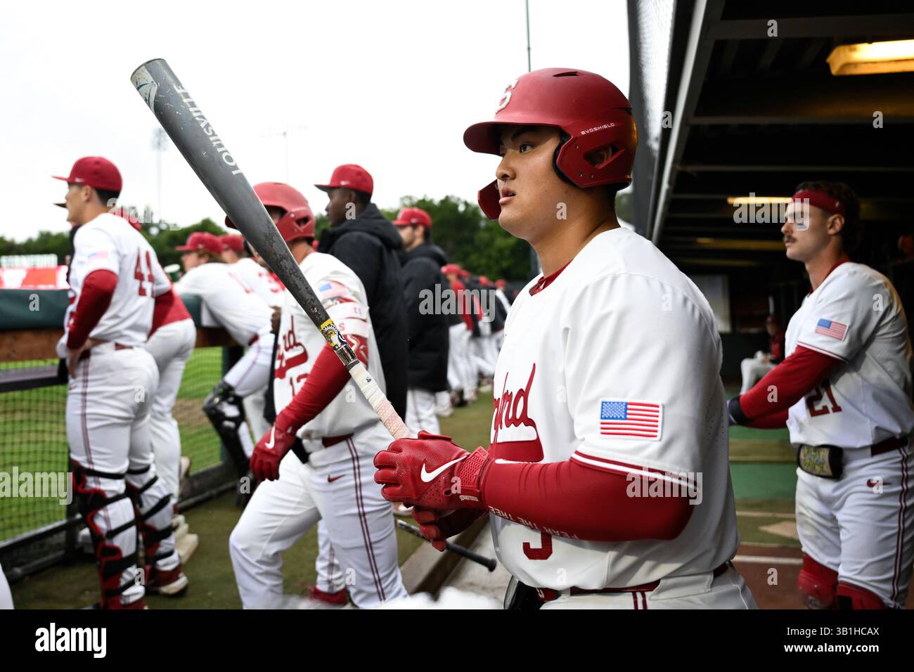 Stanford's Rintaro Sasaki, foreground, stands in the dugout during the ...