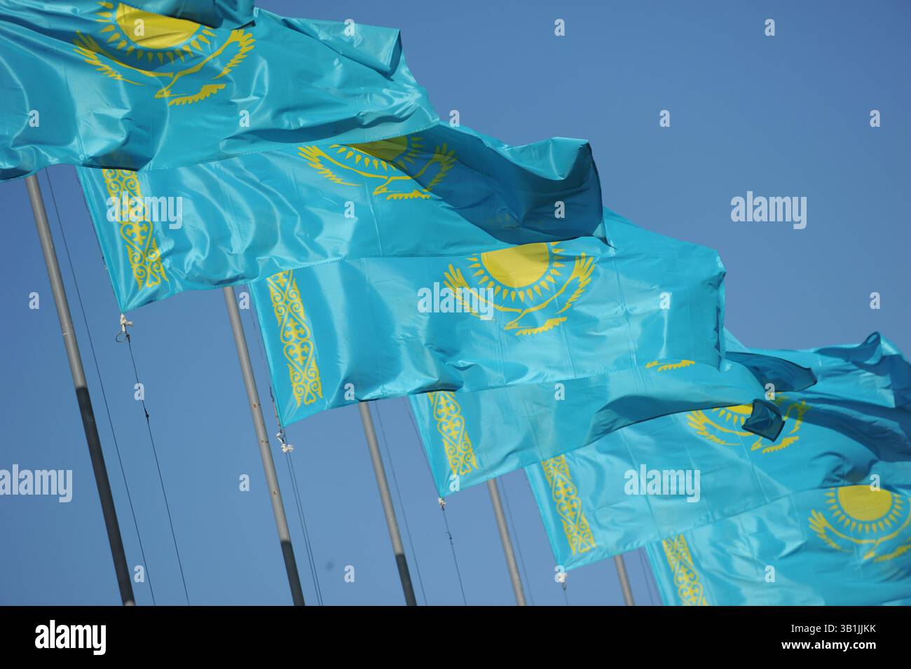 The flags of the Republic of Kazakhstan stand one after the other on ...