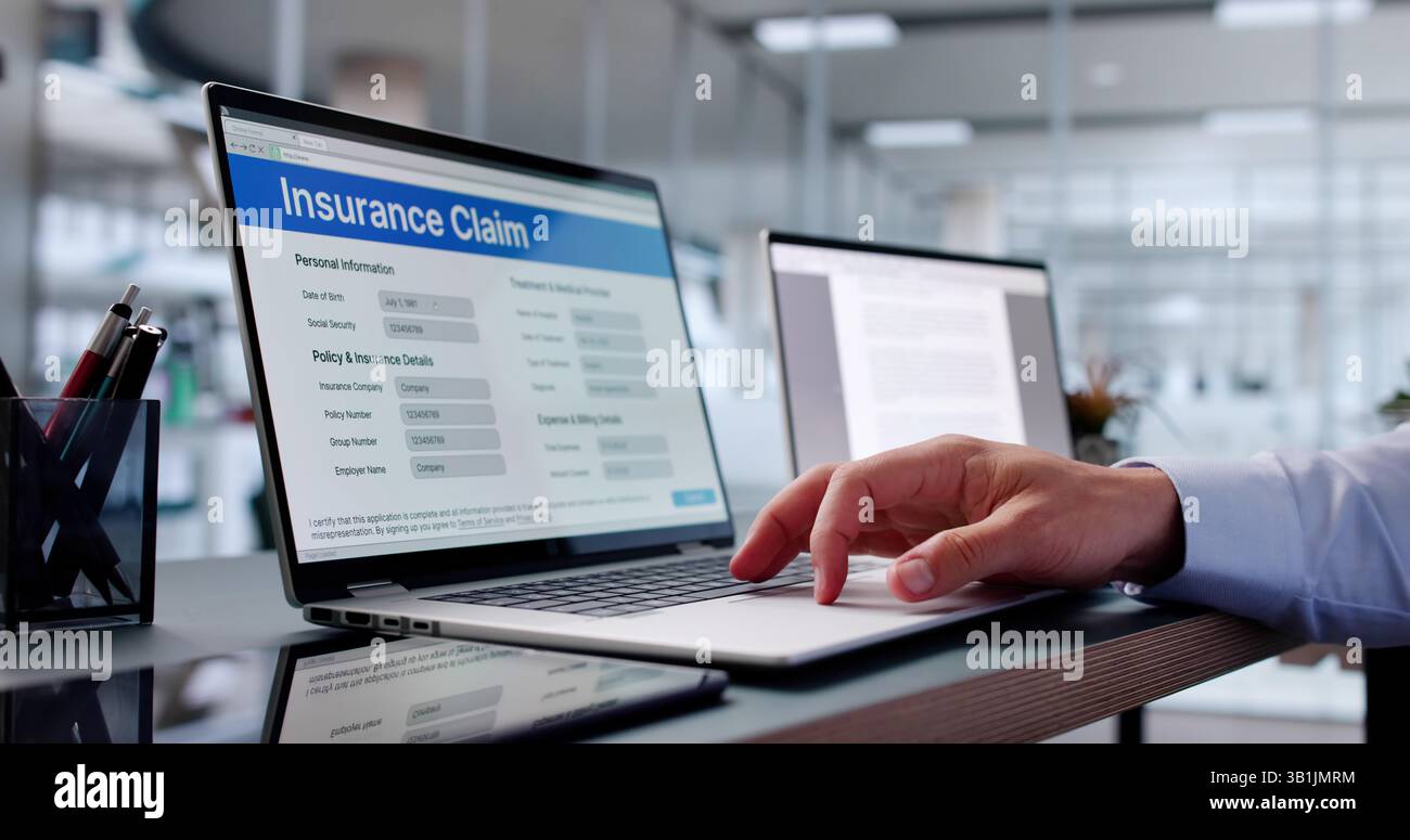 Close-up Of Person Hand Over Insurance Claim Form Stock Photo - Alamy
