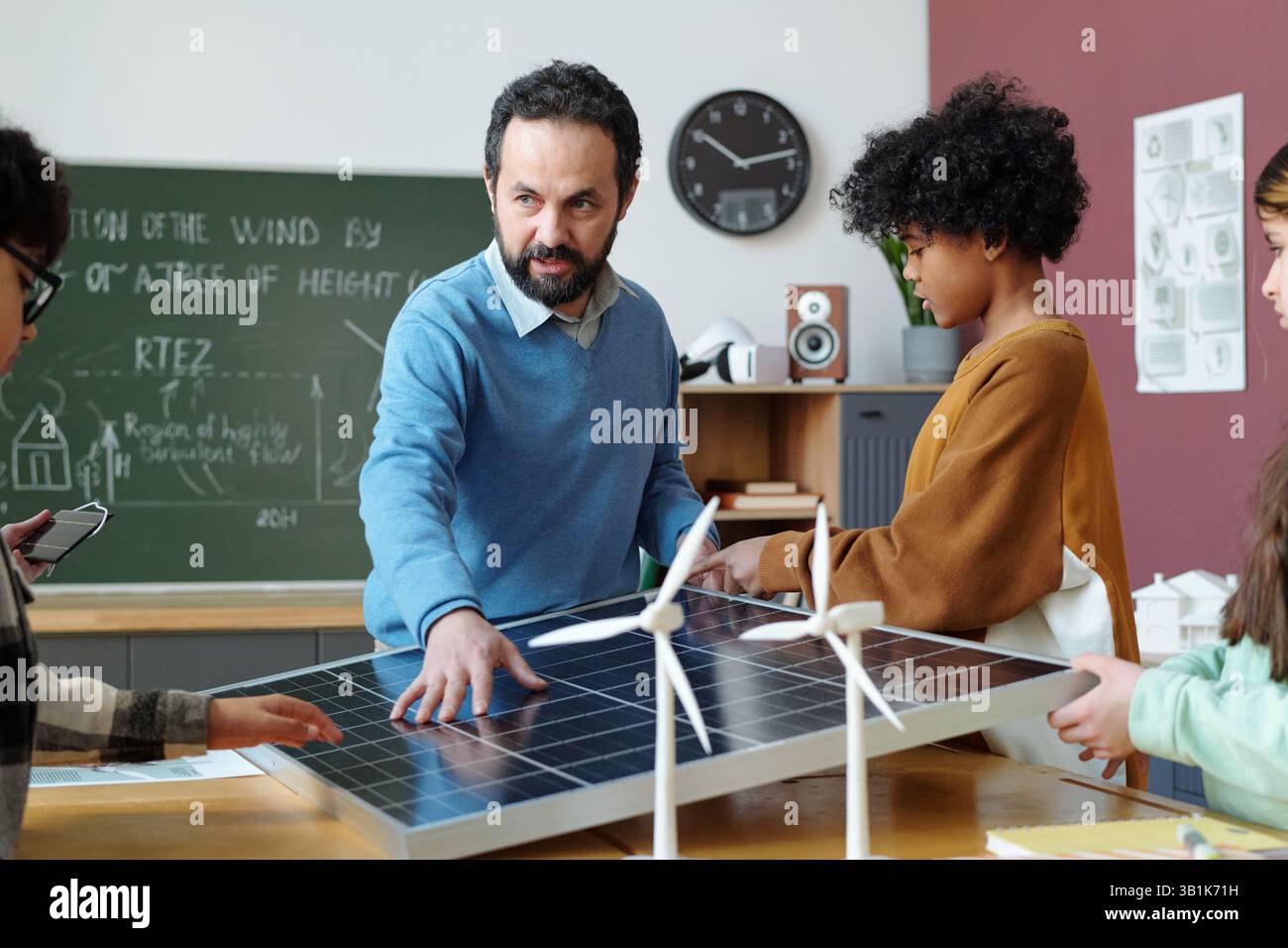 Explaining Solar Panel Function in Classroom Setting Stock Photo - Alamy