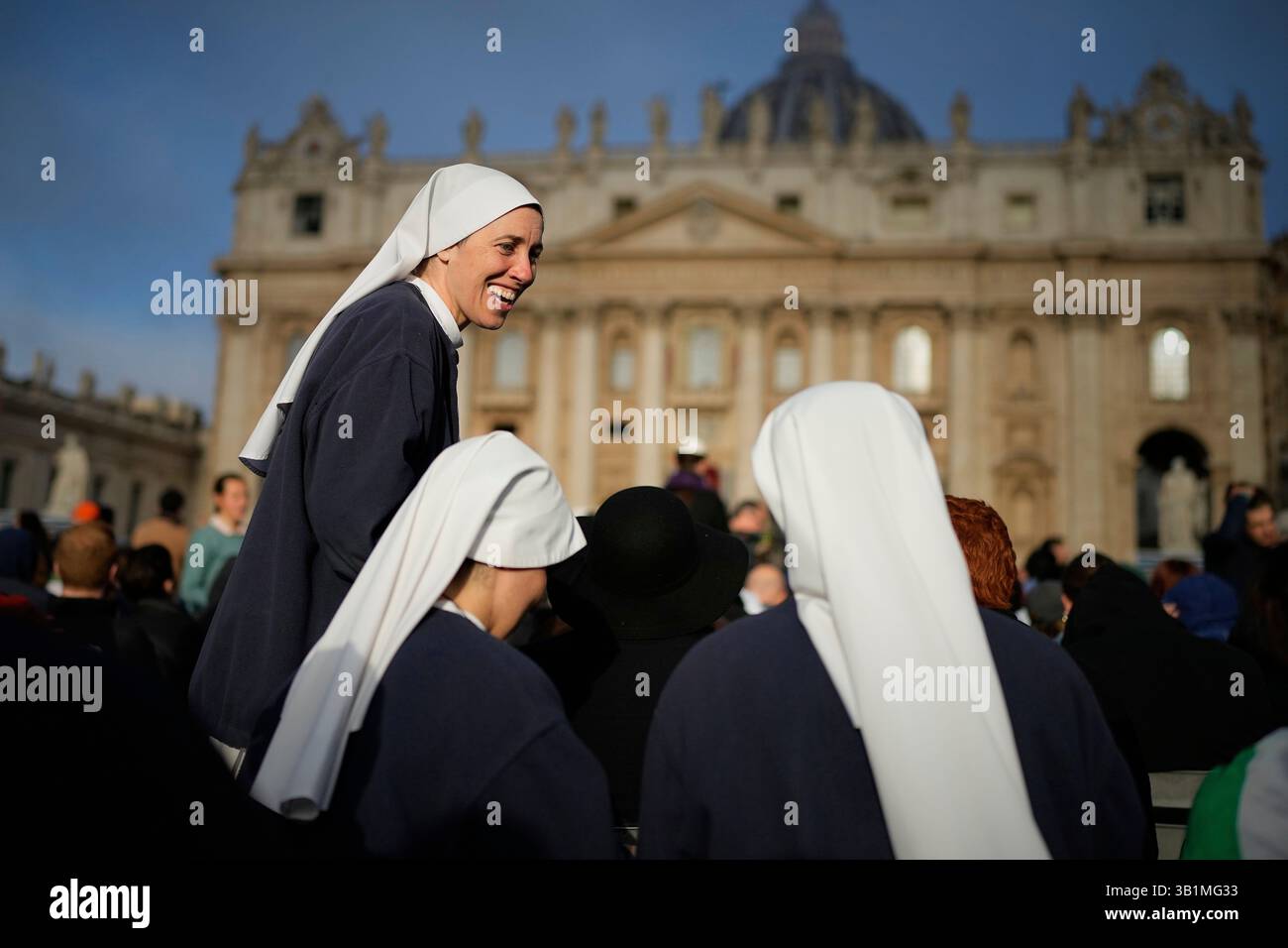Nuns share a laugh as people gather for the funeral of Pope Francis in ...