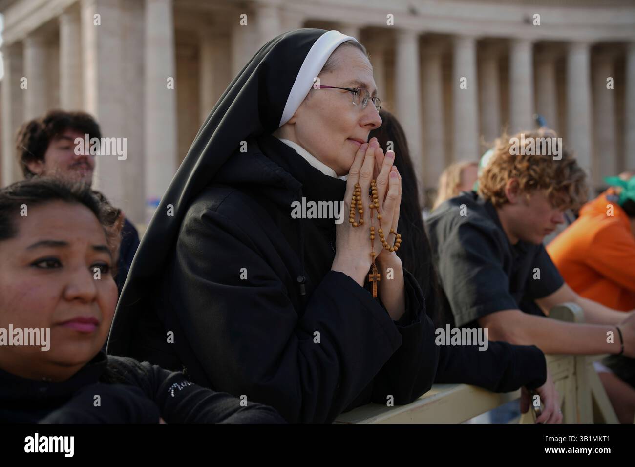 A nun prays as she waits for the funeral of Pope Francis to begin, in ...