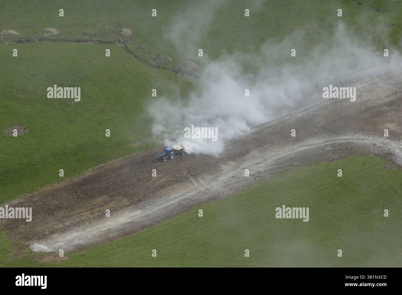 Aerial of a tractor spreading lime on a West Coast dairy farm Stock ...