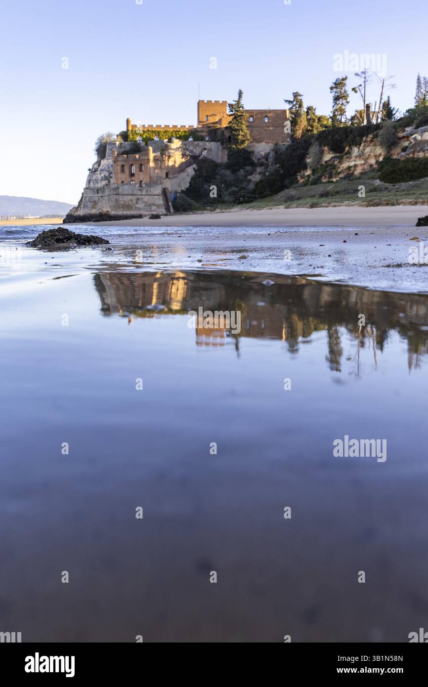 Sunrise on the Atlantic, a castle in the middle of the beach. A ...