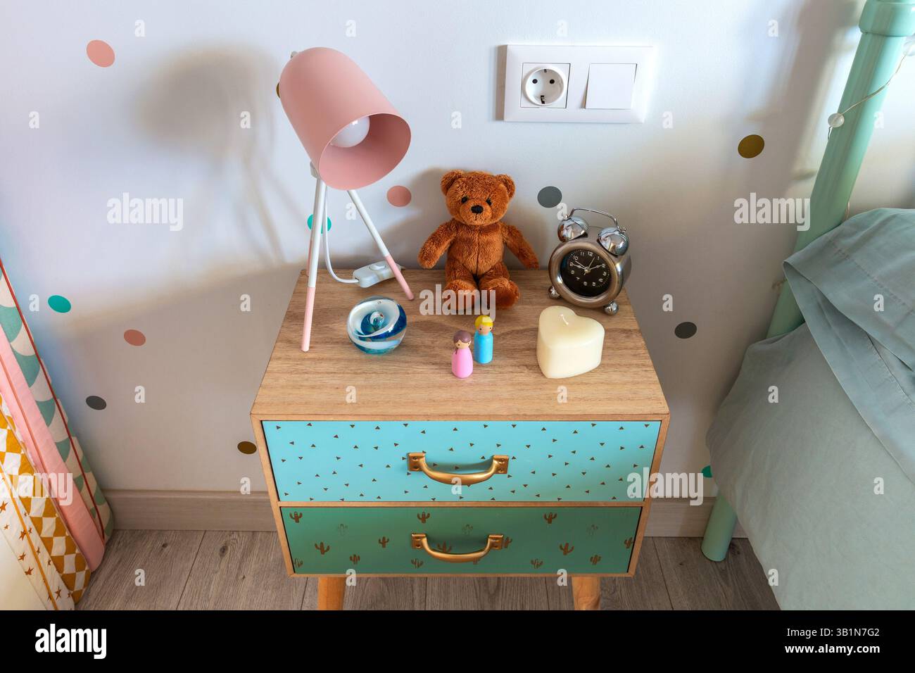 Child's nightstand with teddy bear, lamp, alarm clock and decorative ...