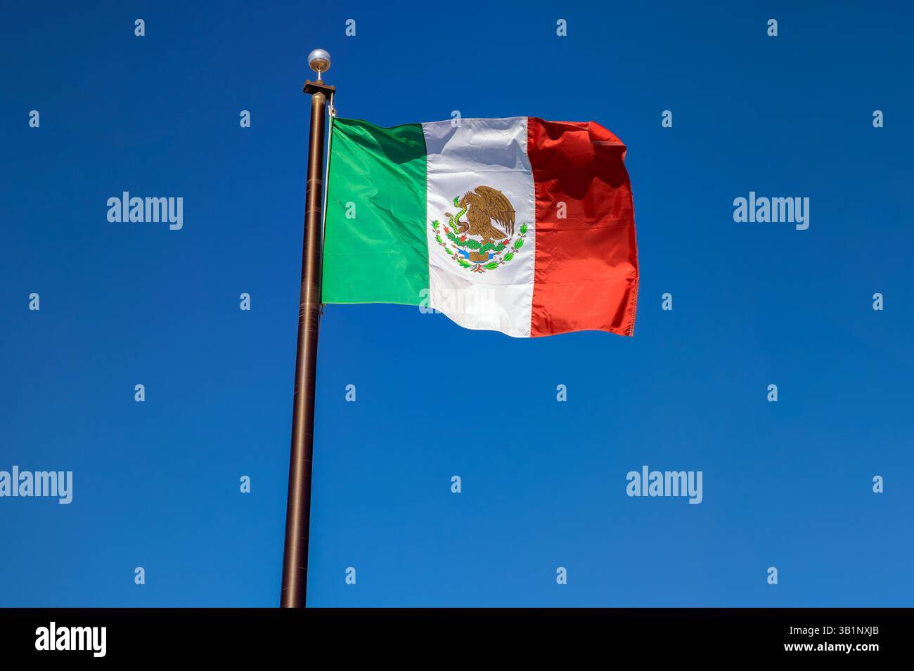 Mexican Flag Waving Against Clear Blue Sky Stock Photo - Alamy