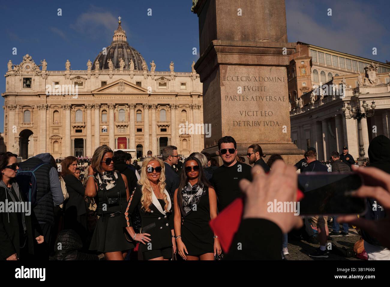 Women pose for a photograph as people wait for the funeral of Pope ...