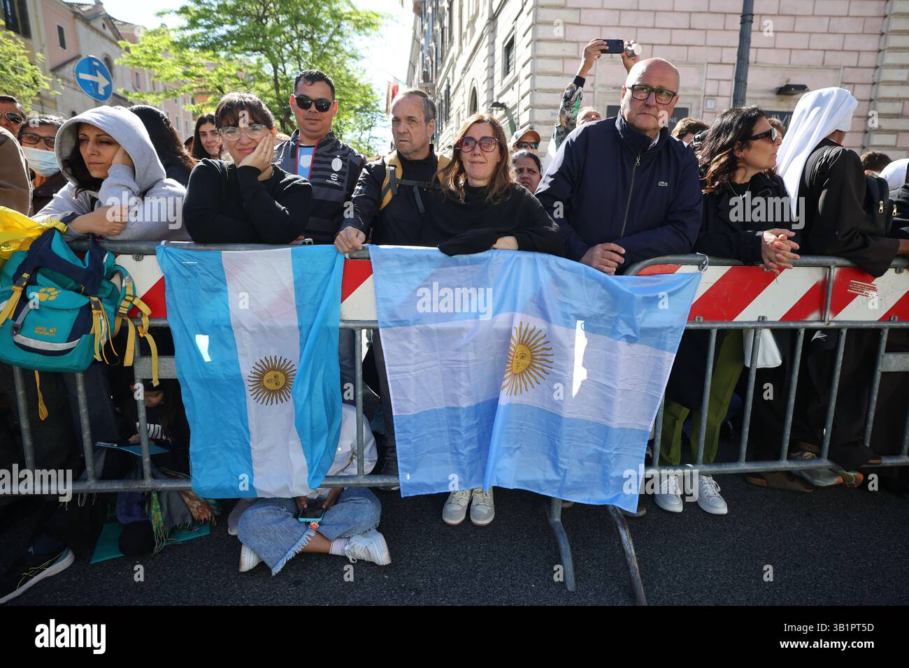 Rom, Italy. 26th Apr, 2025. The faithful hold Argentinian flags and ...