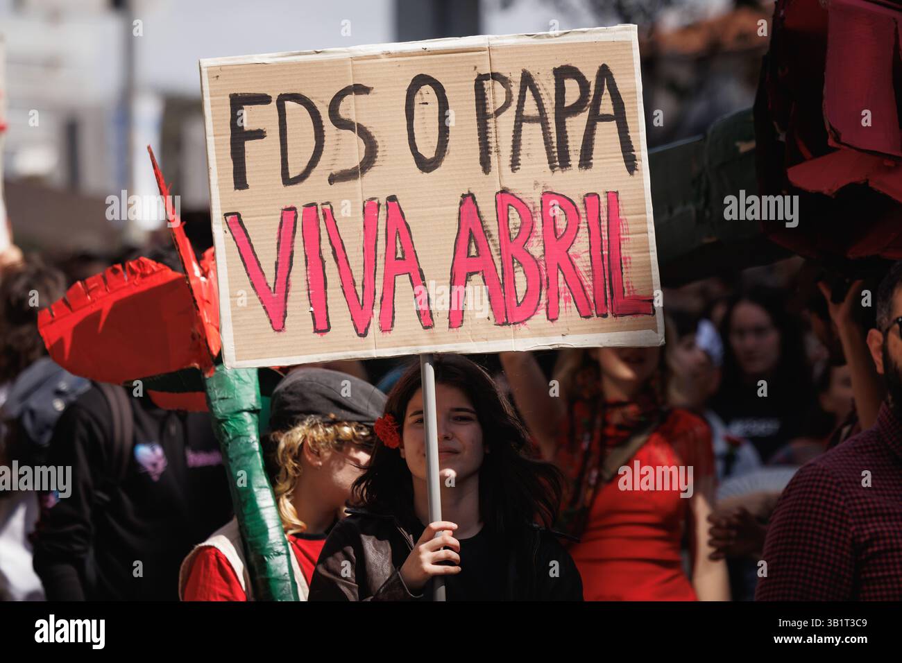 Contains profanity.A young woman is pictured holding a placard ...