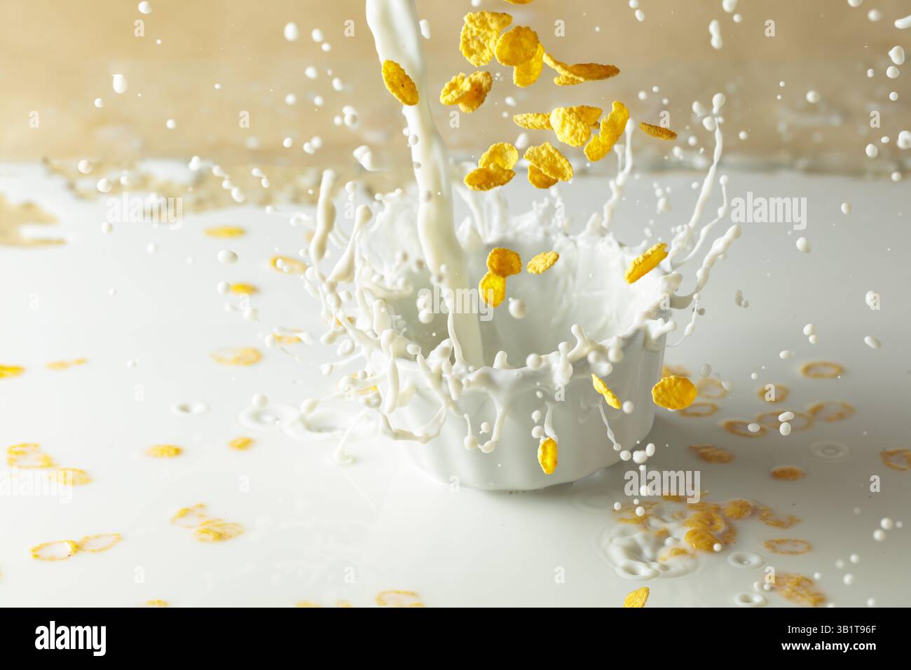 Dry honey cornflakes fall into a ceramic bowl creating beautiful milk ...