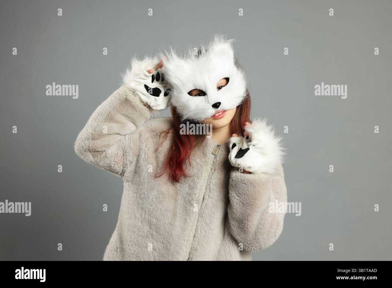 Quadrobics. Girl wearing cat mask and gloves on grey background Stock ...