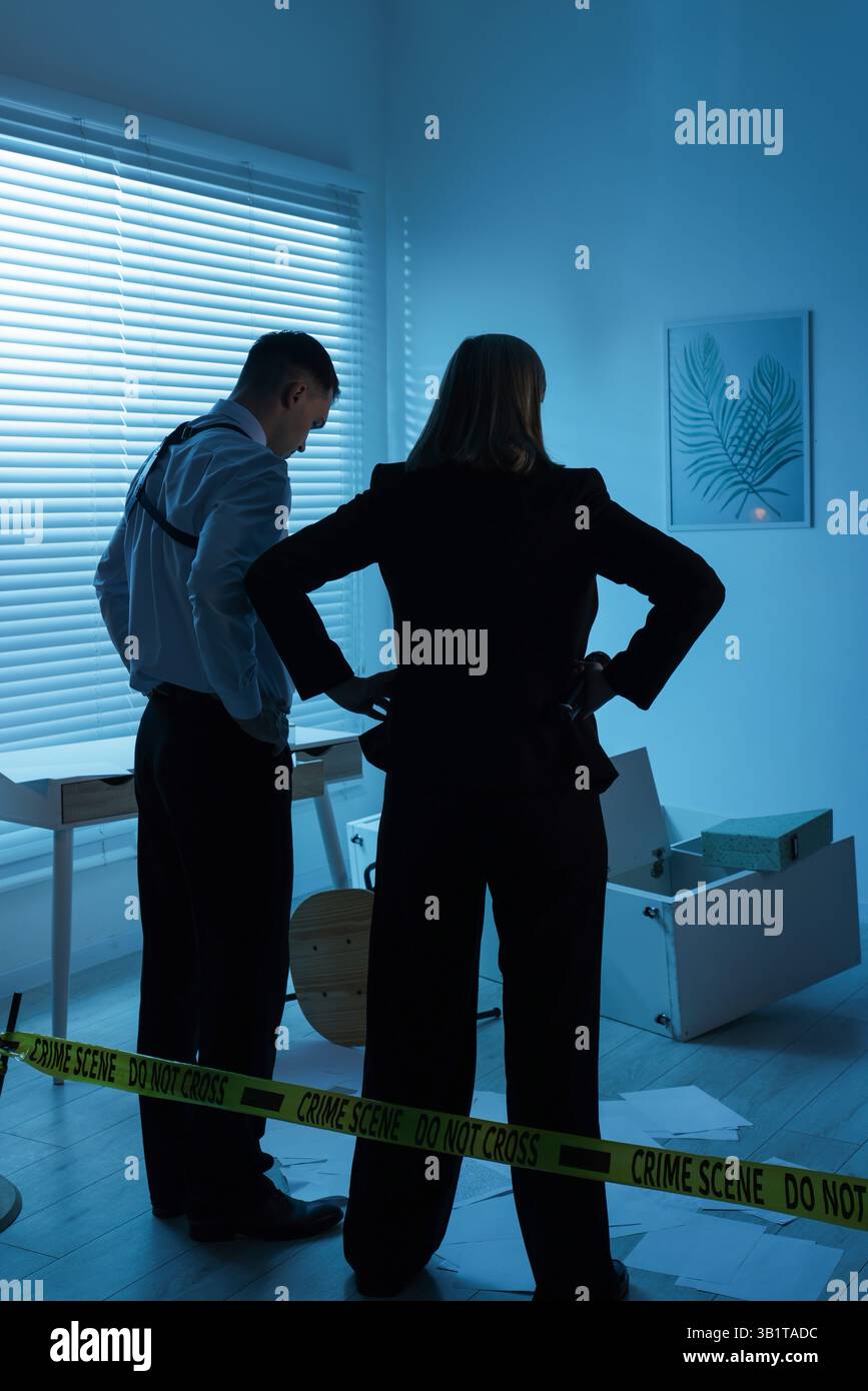 Forensic experts working at crime scene indoors, back view Stock Photo ...