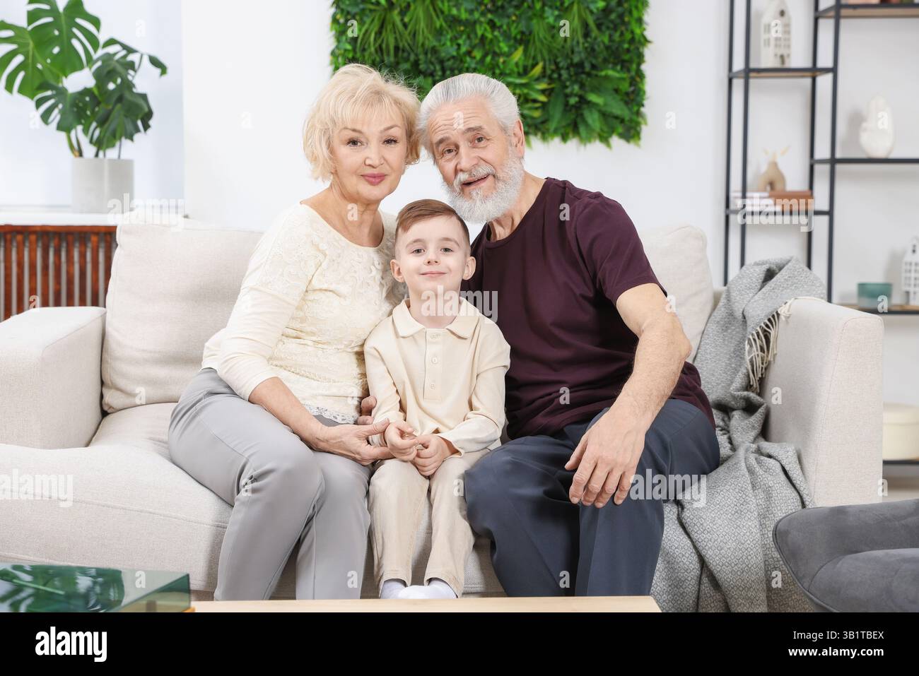 Grandparents with their grandson on sofa at home Stock Photo - Alamy