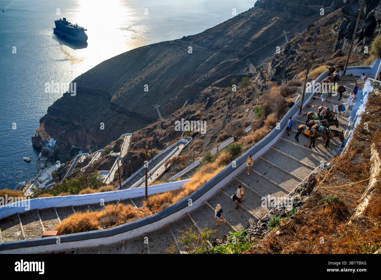 Santorini riding a donkey on the cliff path between Ammoudi Bay and Oia ...