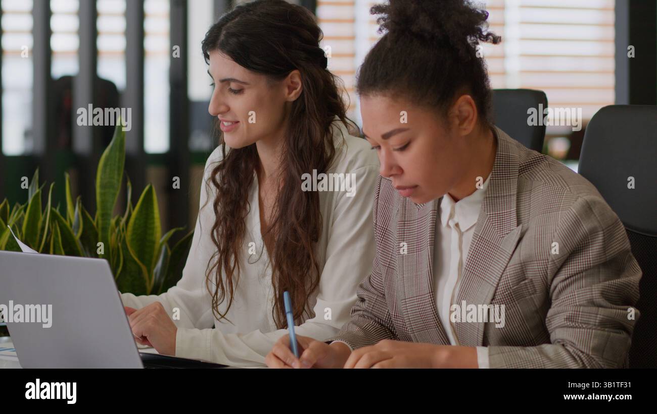 Multiethnic business partners African American Caucasian women ...