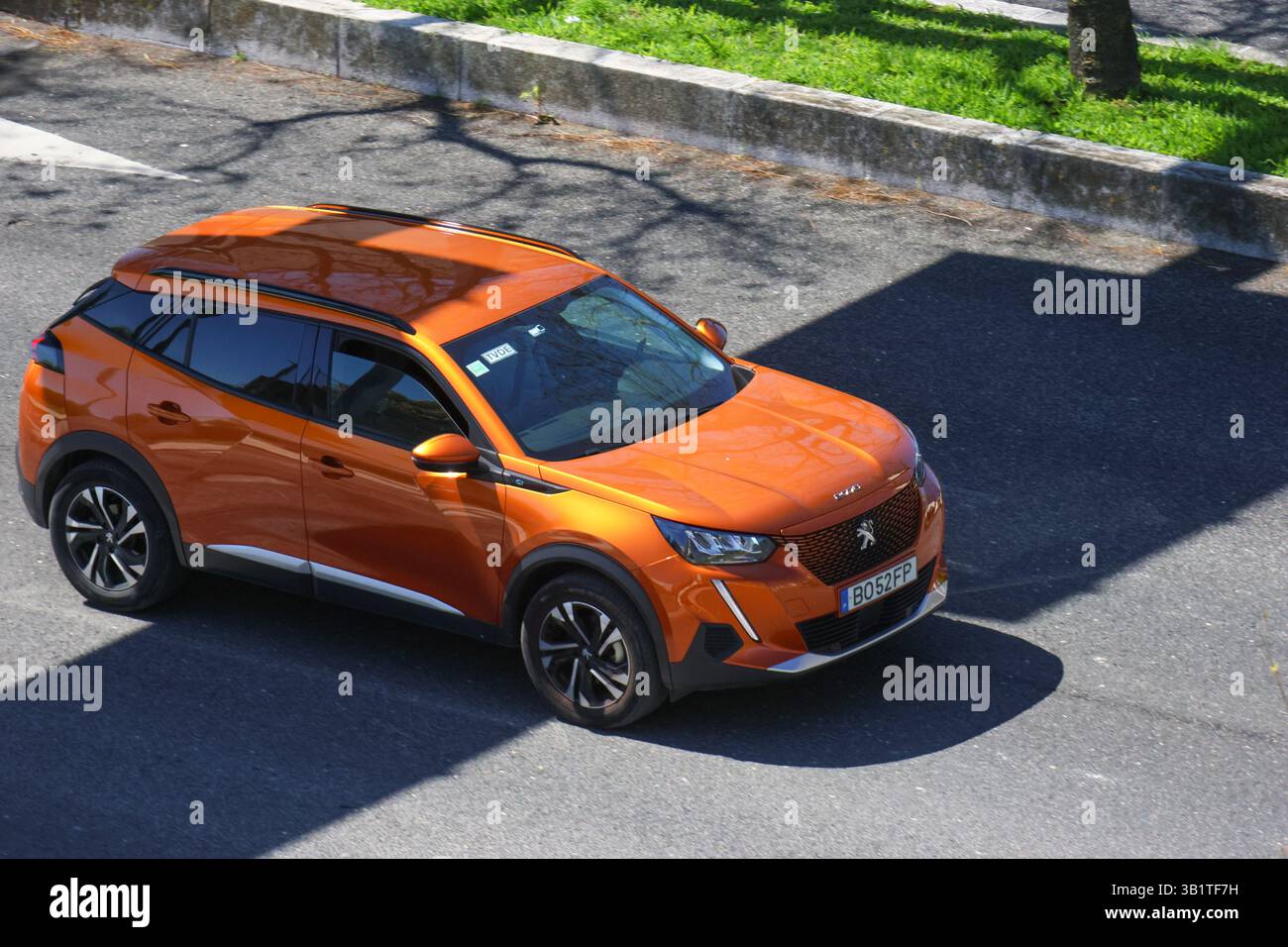 Modern orange peugeot 2008 suv driving on asphalt road next to a sidewalk Stock Photo - Alamy