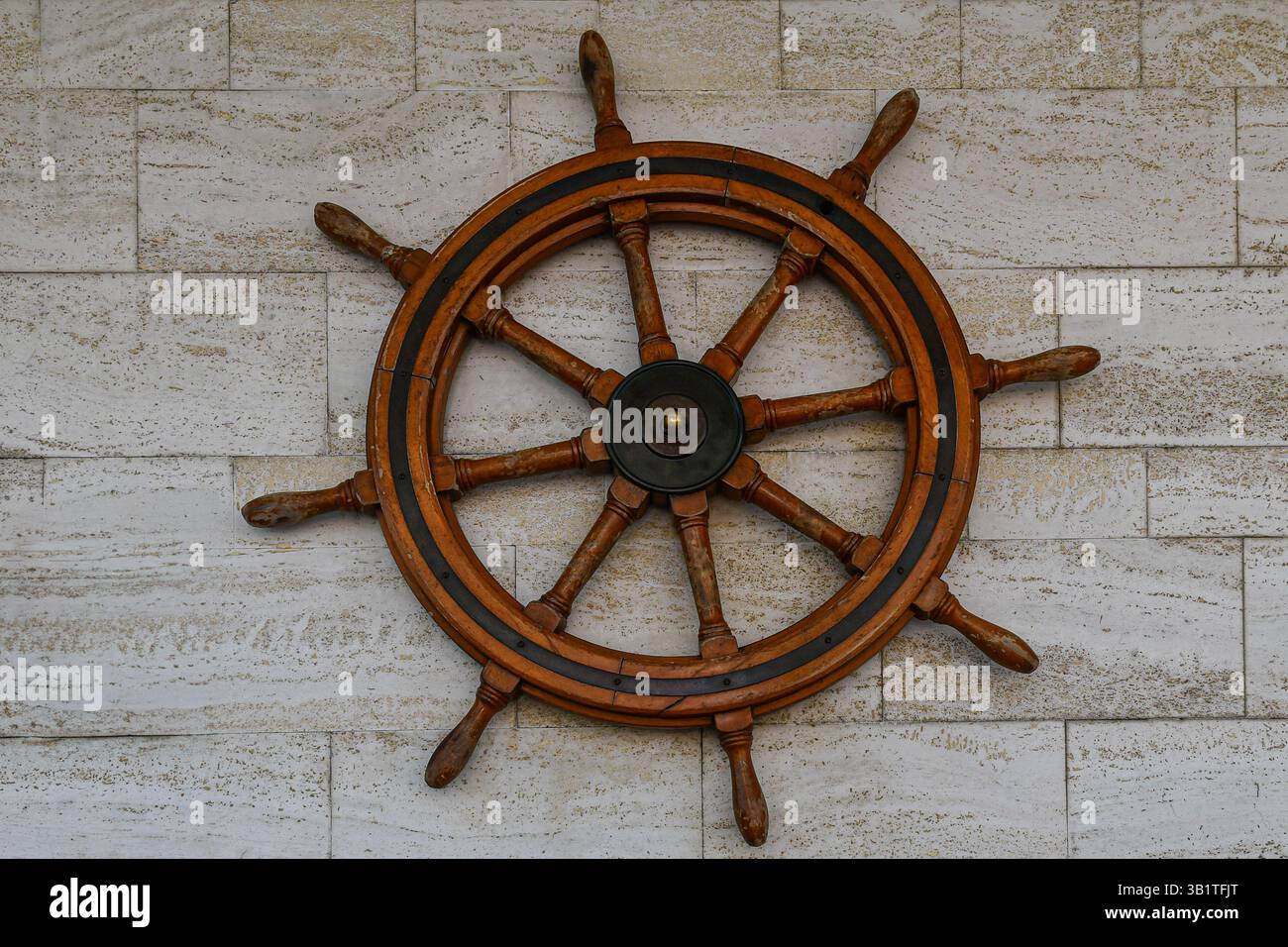 An old wooden rudder hanging on a stone brick wall, Italy Stock Photo ...