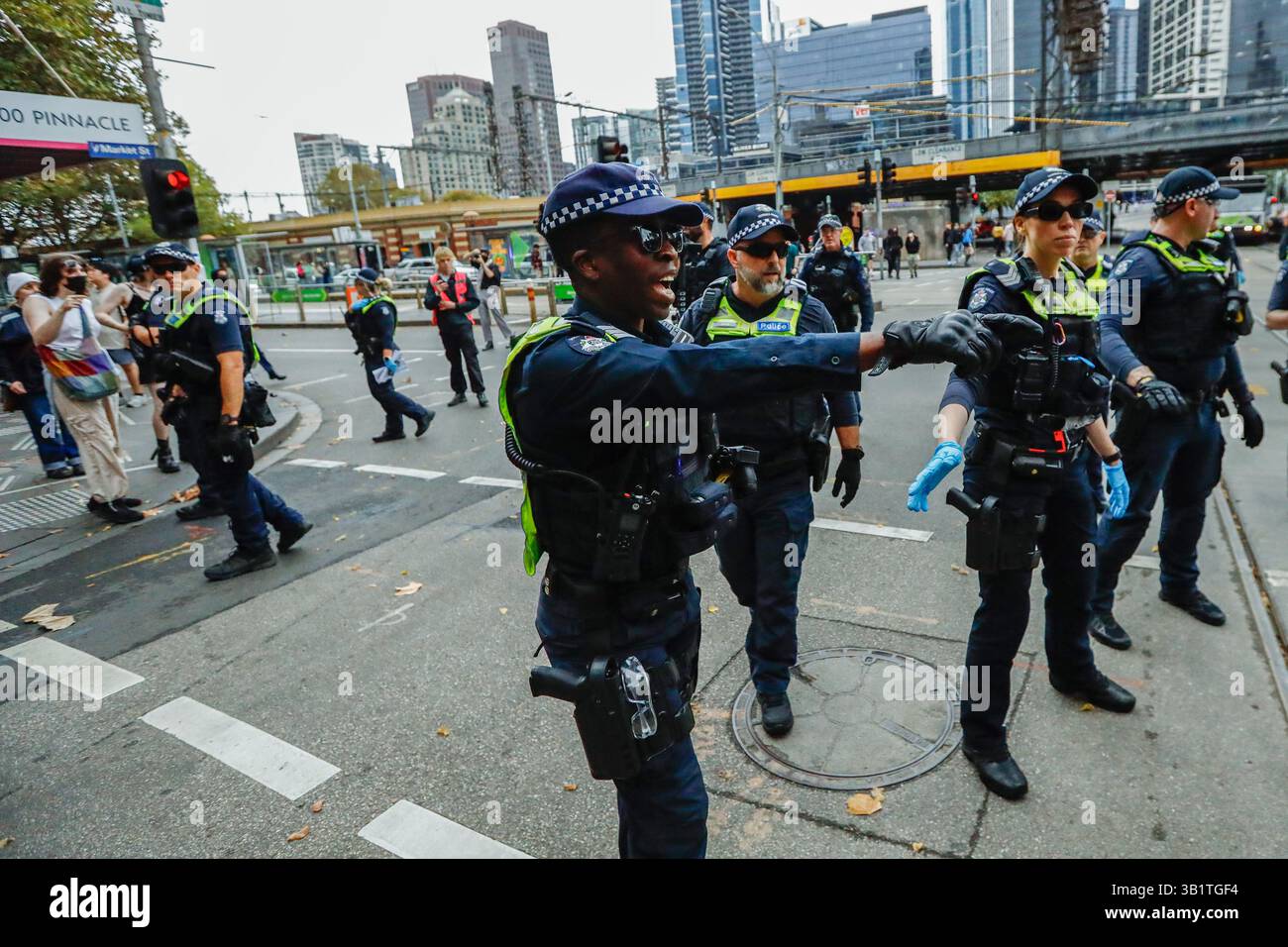 A Victoria Police officer shouts at a protester during a demonstration ...