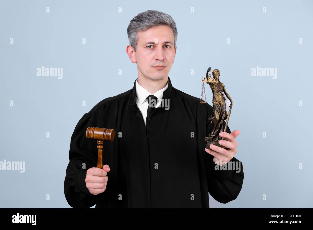 Judge with mallet and statue of Lady Justice on grey background Stock ...