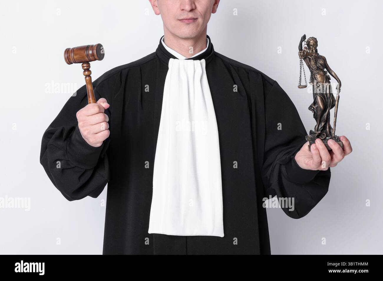 Judge with mallet and statue of Lady Justice on light background ...