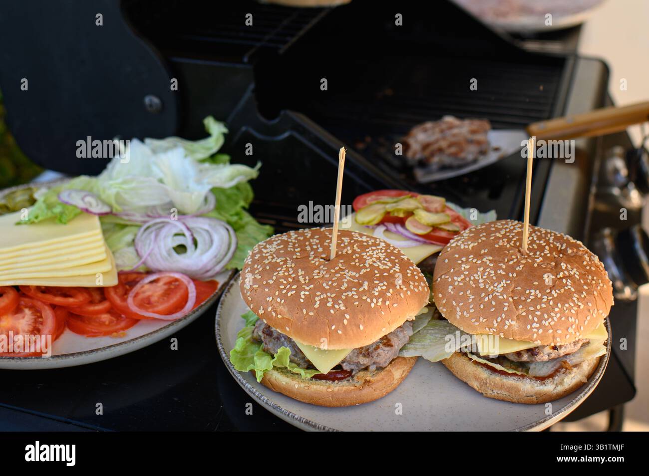 Juicy, delicious burgers ready to serve standing near the grill Stock ...