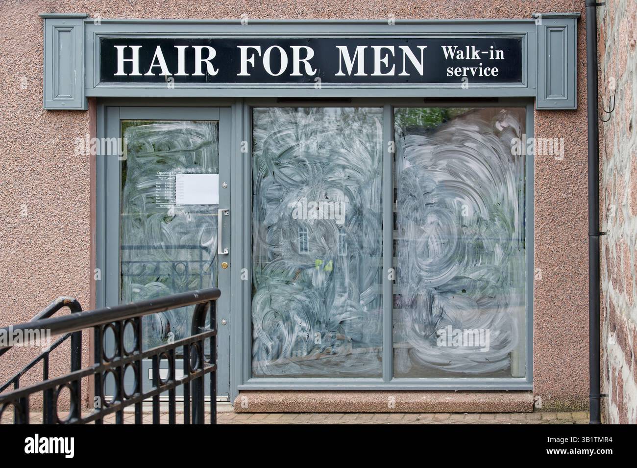 Two gents barber shops next to each other on high street Stock Photo ...