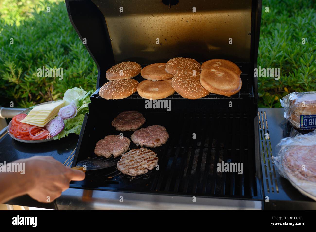 A man is standing near the grill on a terrace, grilling meat Stock ...